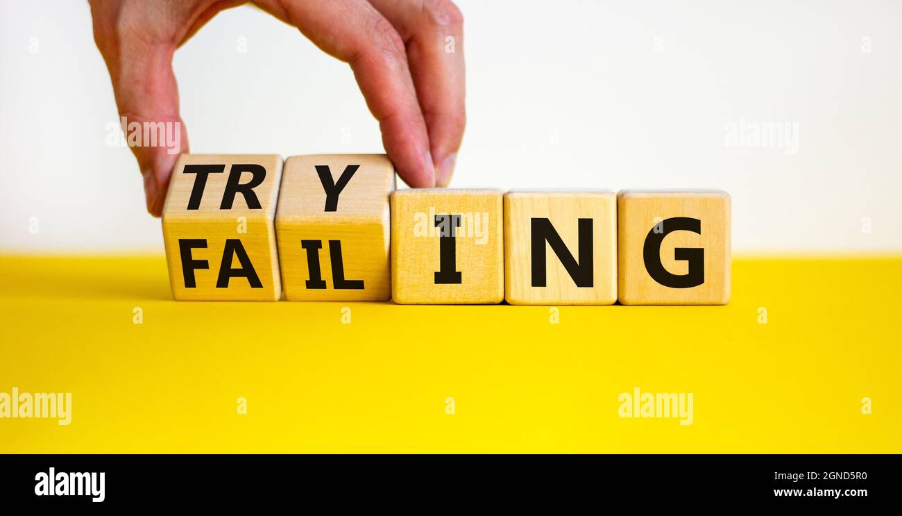 Failing or trying symbol. Businessman turns wooden cubes and changes ...
