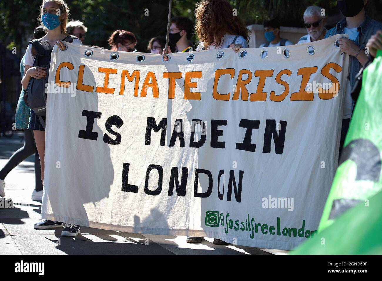 London, UK. 24th Sep, 2021. Activists hold a banner voicing their ...