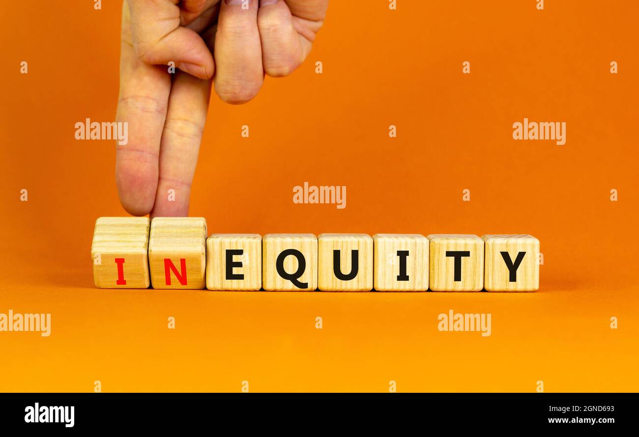 Inequity or equity symbol. Businessman turns wooden cubes and changes ...