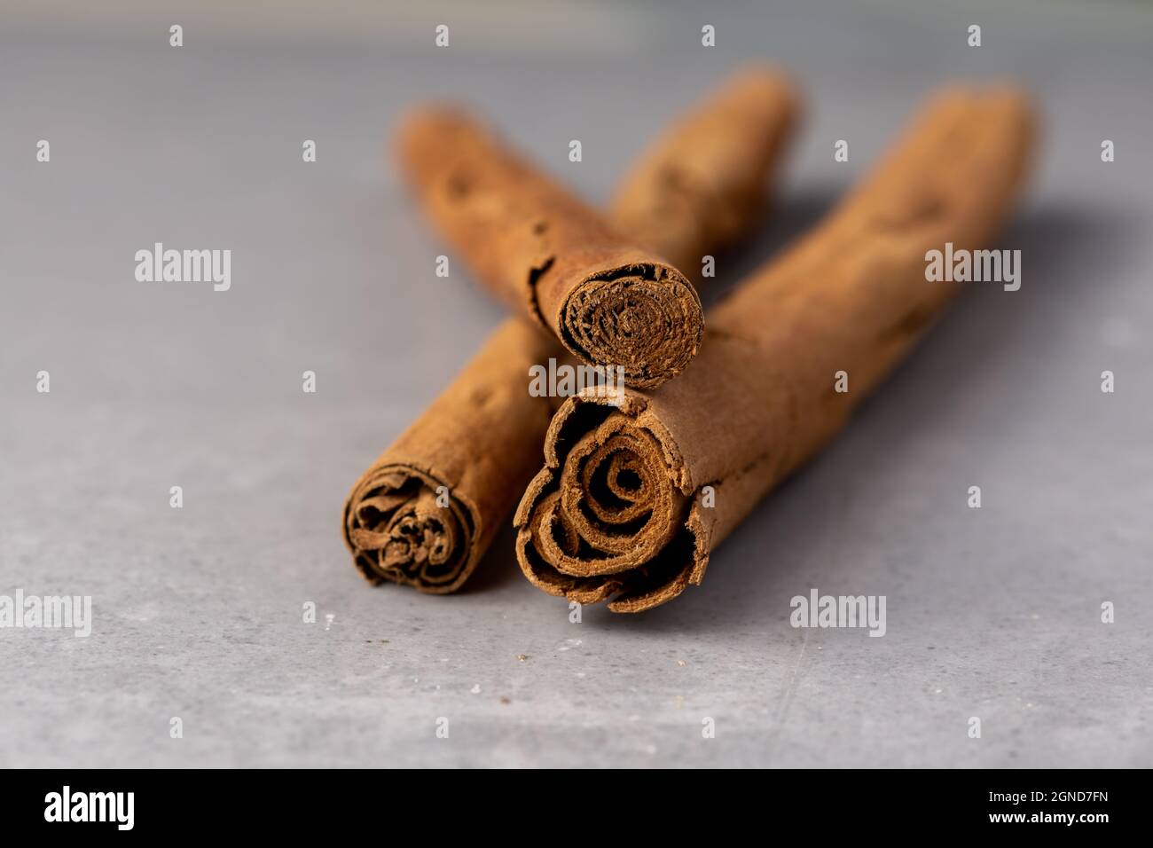 Cinnamon sticks led down on a grey slate texture background close up ...