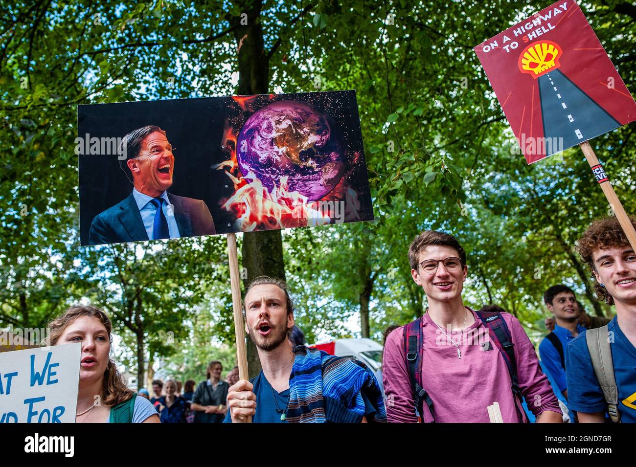 A protester holds a placard with a picture of the Dutch president Mark ...