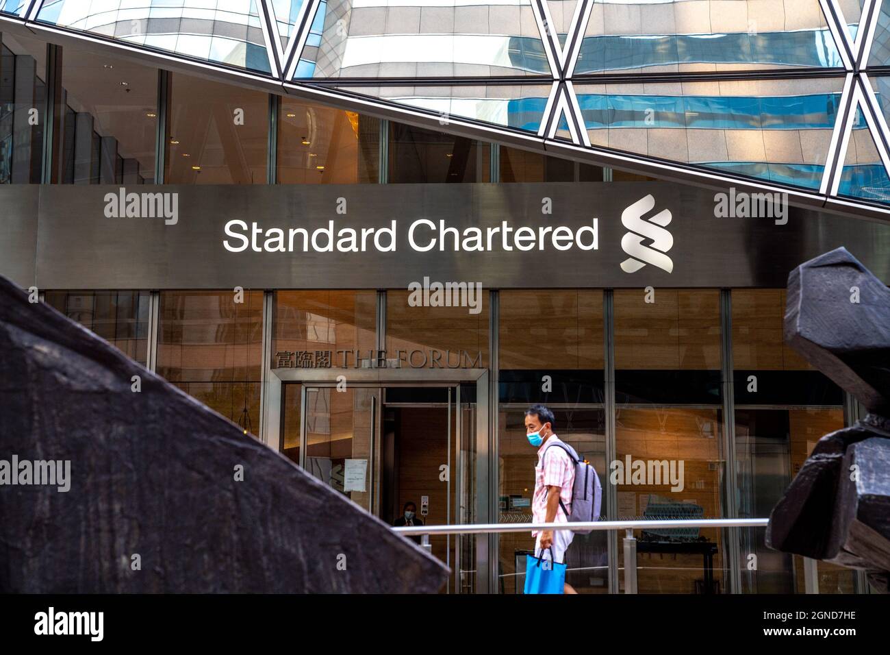A man walks past a Standard Chartered building. (Photo by Katherine ...