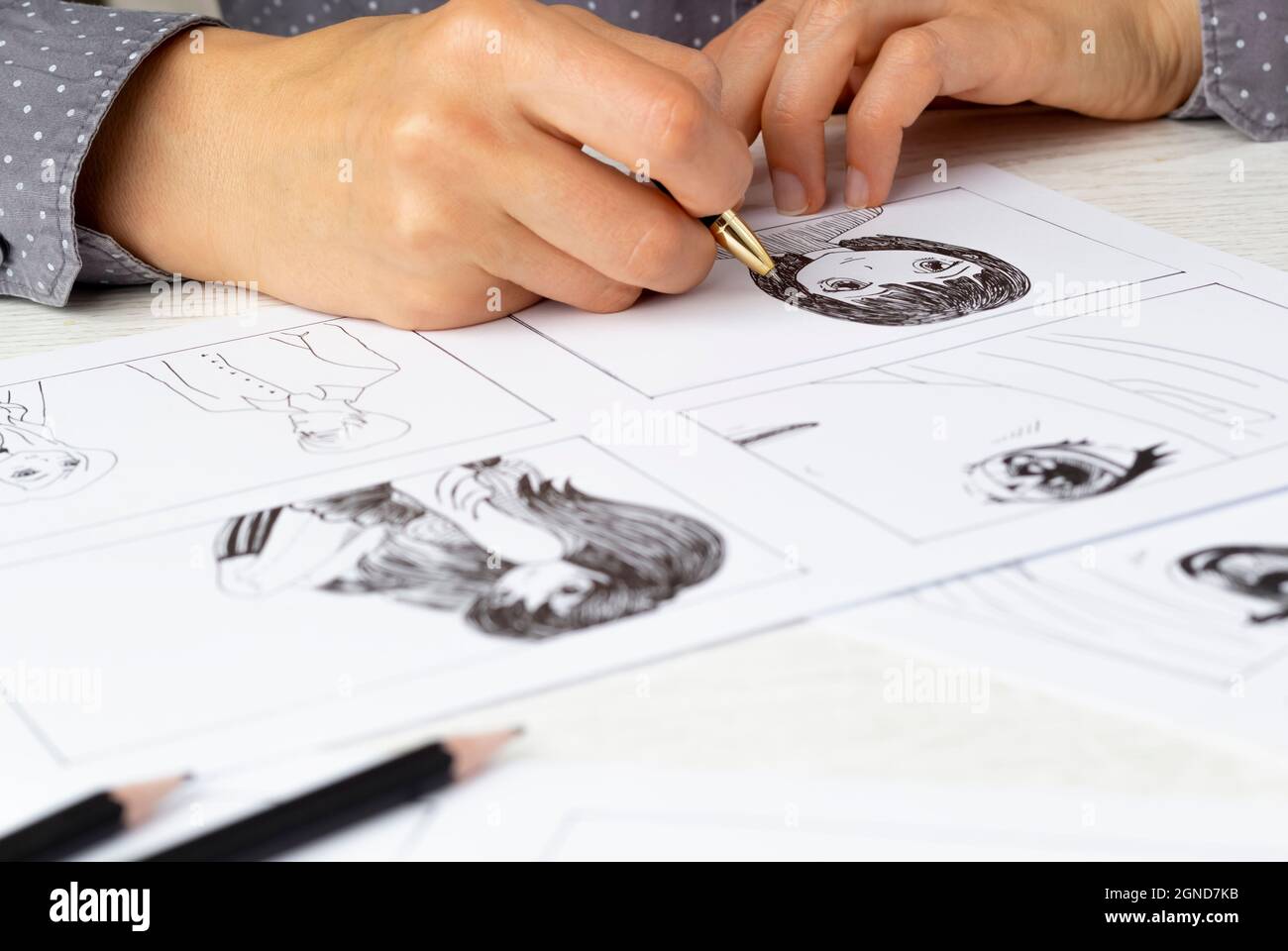 Manga style. The artist draws anime comics on paper. The illustrator ...