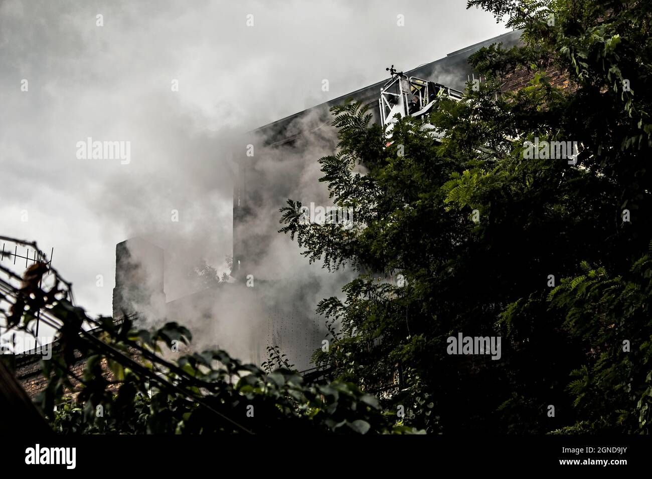 Fire in a residential five-story building. Firefighters in the basket ...