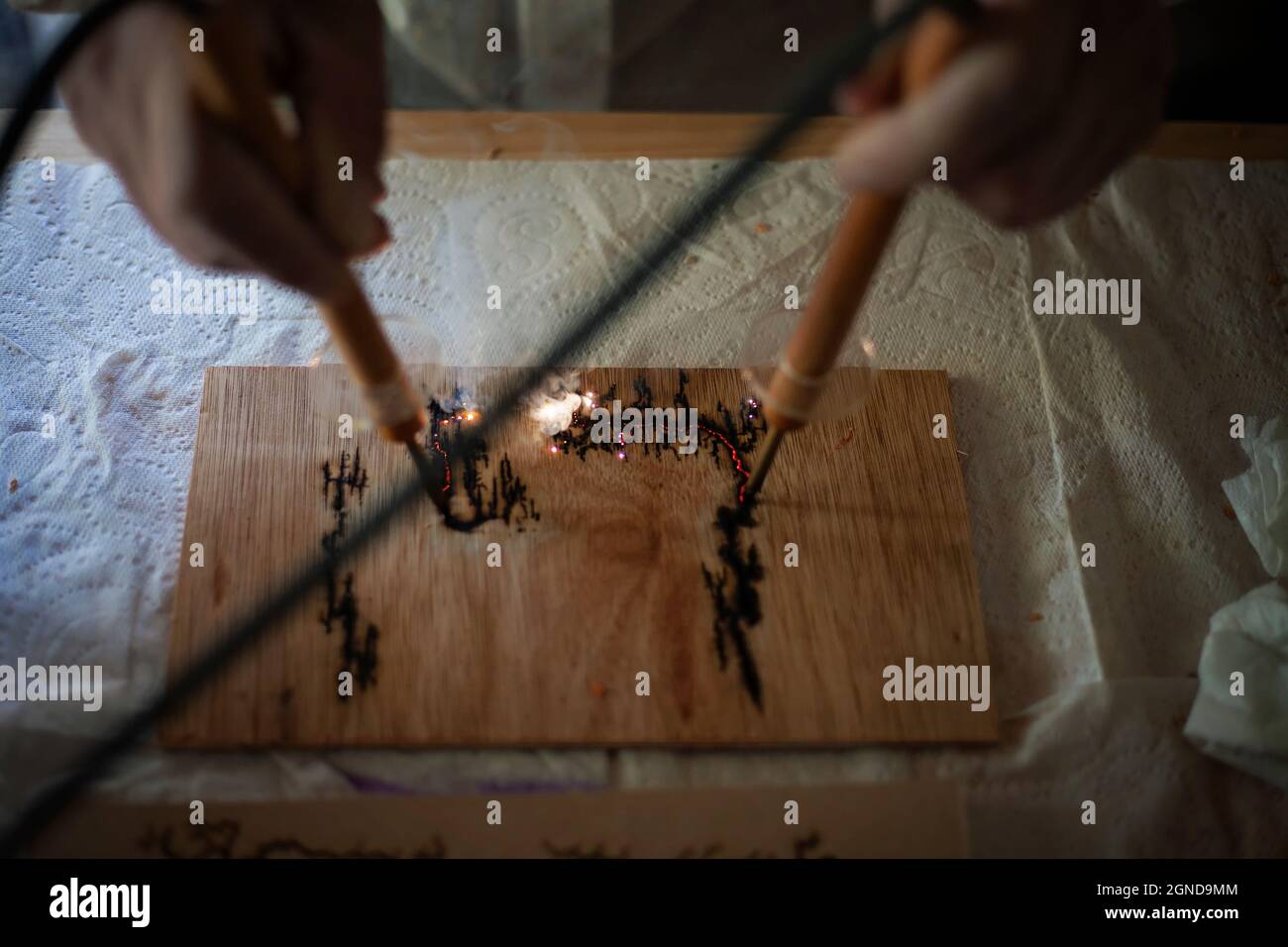 A Man using a Lichtenberg machine.A high voltage piece of equipment ...