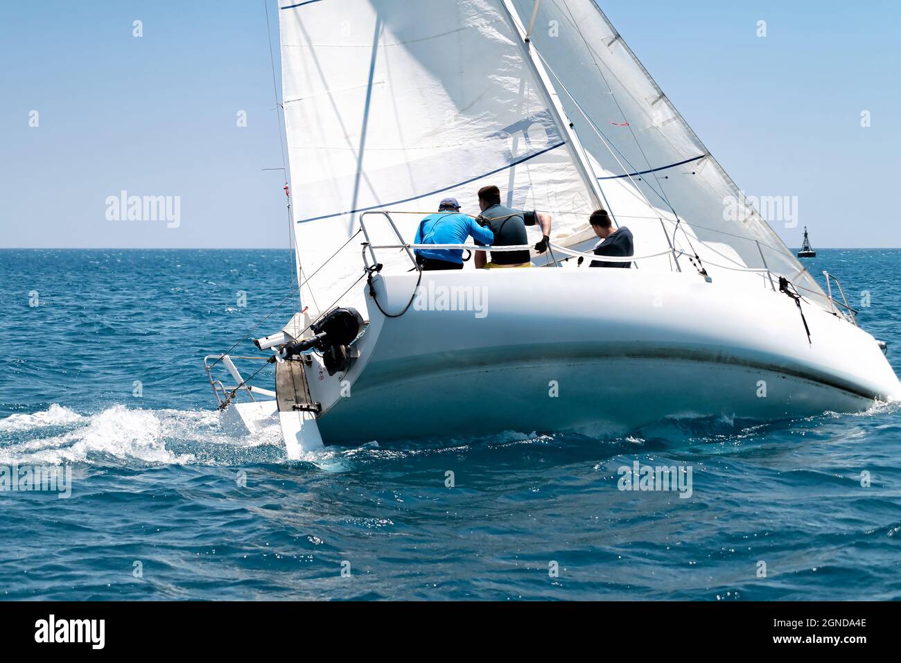 Sailing crew on sailboat during regatta Stock Photo - Alamy