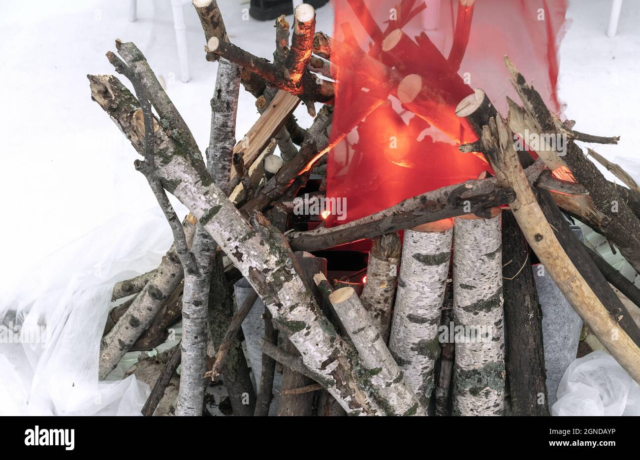 Artificial bonfire with birch logs and red lighting Stock Photo - Alamy
