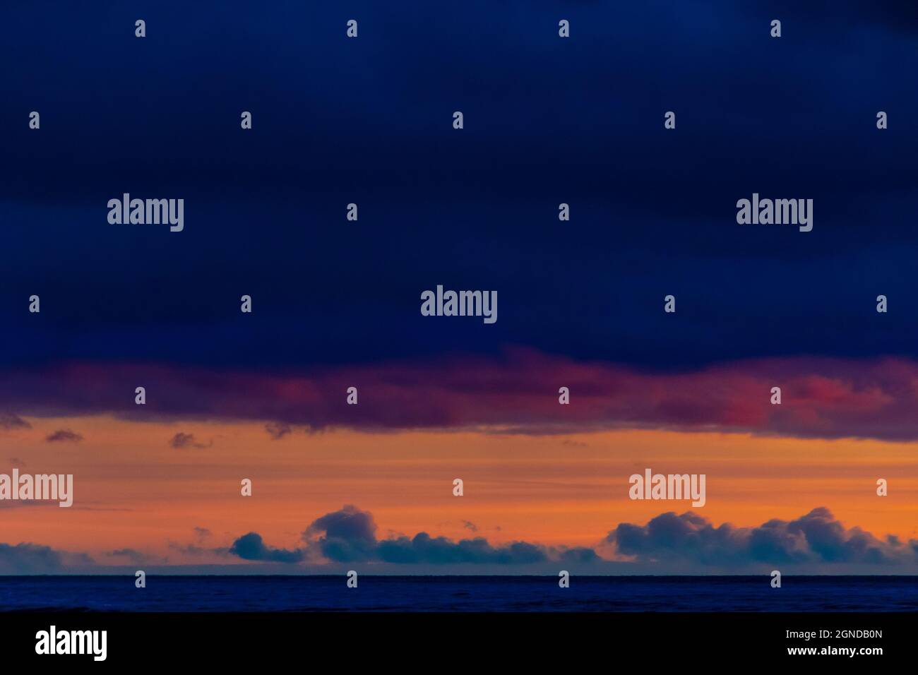 Beautiful view of the calm sea gleaming under the sunrays during sunset ...