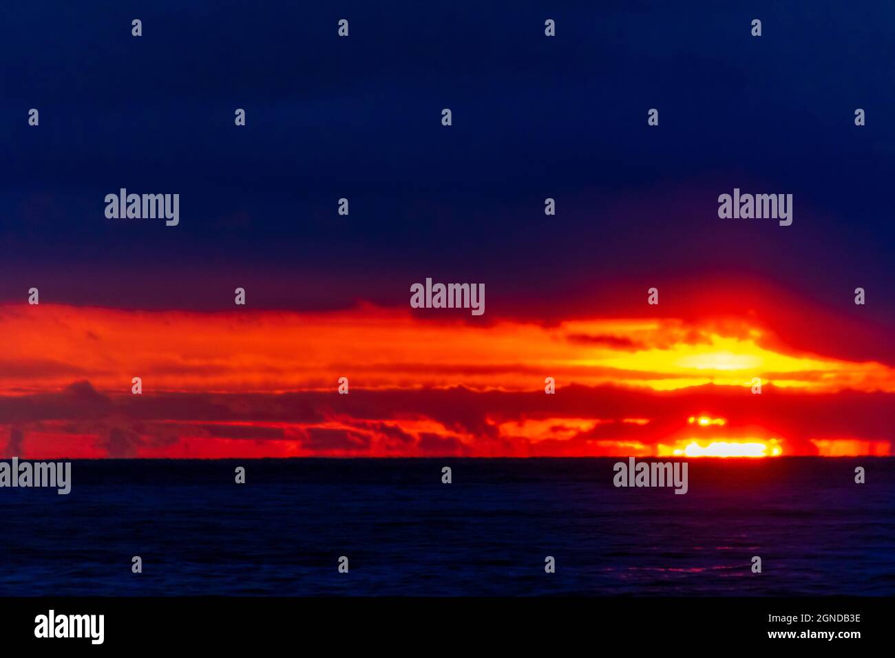 Beautiful view of the calm sea gleaming under the sunrays during sunset ...