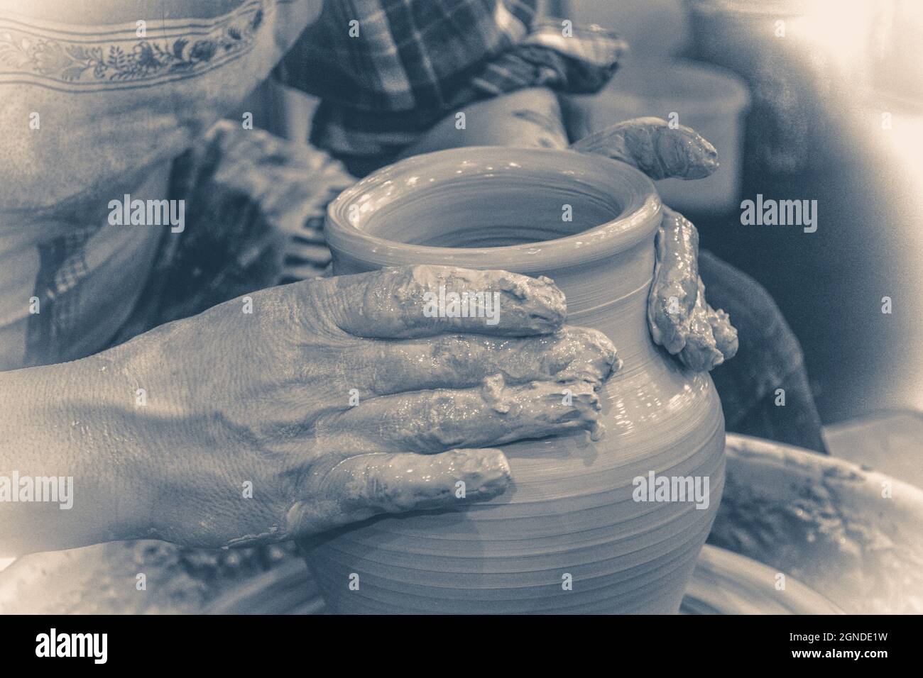 Old vintage photo. The potter molds clay jug pot Stock Photo - Alamy