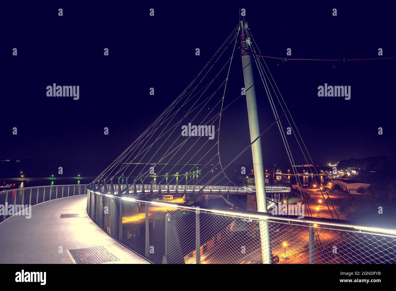 Illuminated pedestrian bridge at night Stock Photo - Alamy
