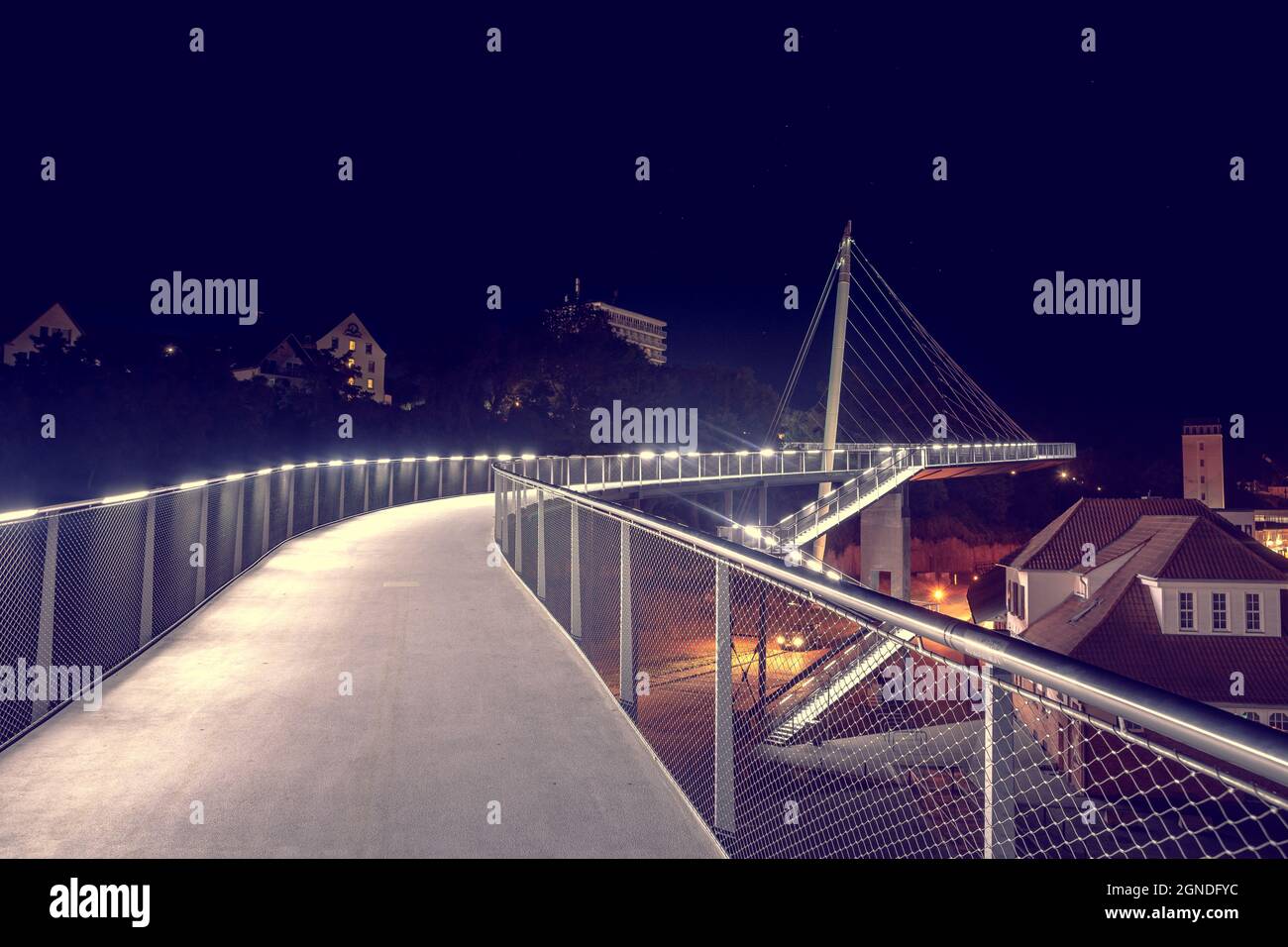 Illuminated pedestrian bridge at night Stock Photo - Alamy