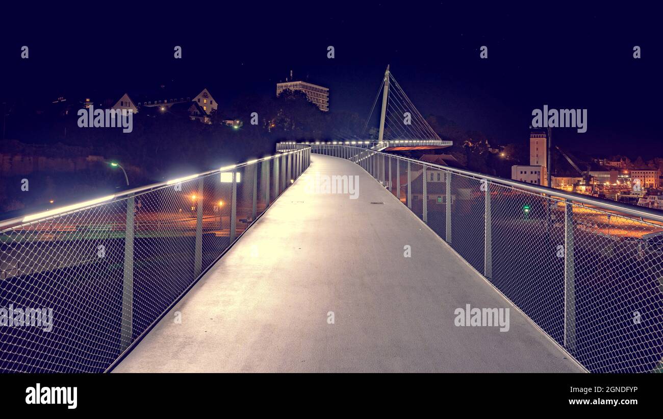 Illuminated pedestrian bridge at night Stock Photo - Alamy