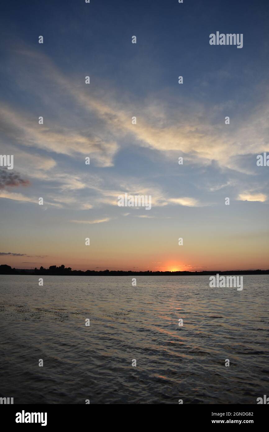 Closeup shot of a beautiful sunset over a sea under the blue sky Stock ...