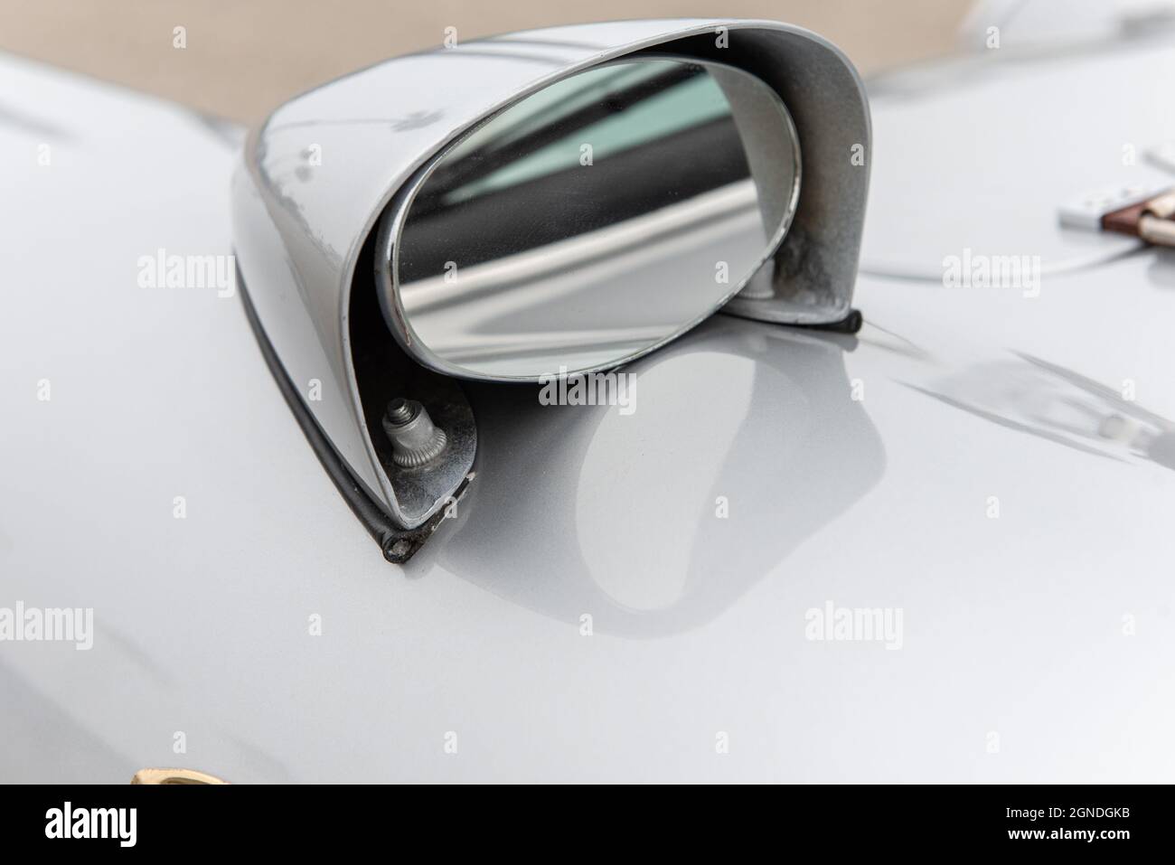 Oval shaped rear view mirror gives driver of this vintage car a look at ...