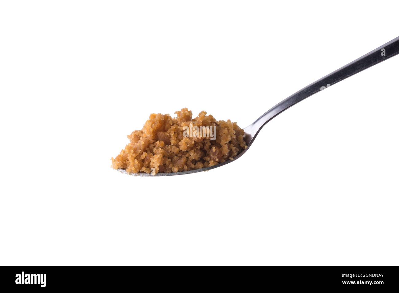 palm sugar on a spoon, golden brown color unrefined sugar product also ...
