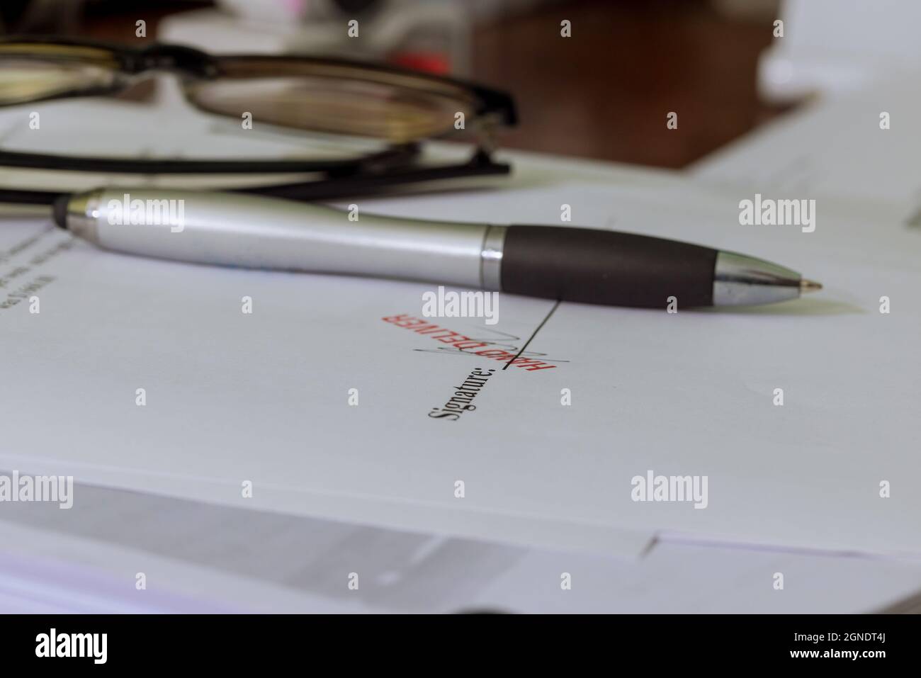 Close-up of with pen over document signature at official paper Stock ...