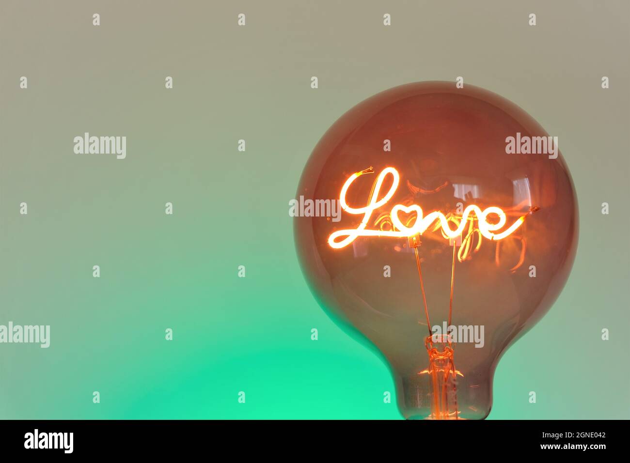 Love.Light bulb with the inscription love on an emerald background ...