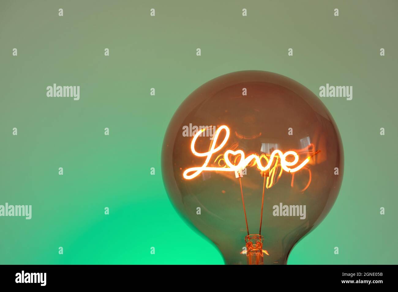 Love.Light bulb with the inscription love on an emerald background ...
