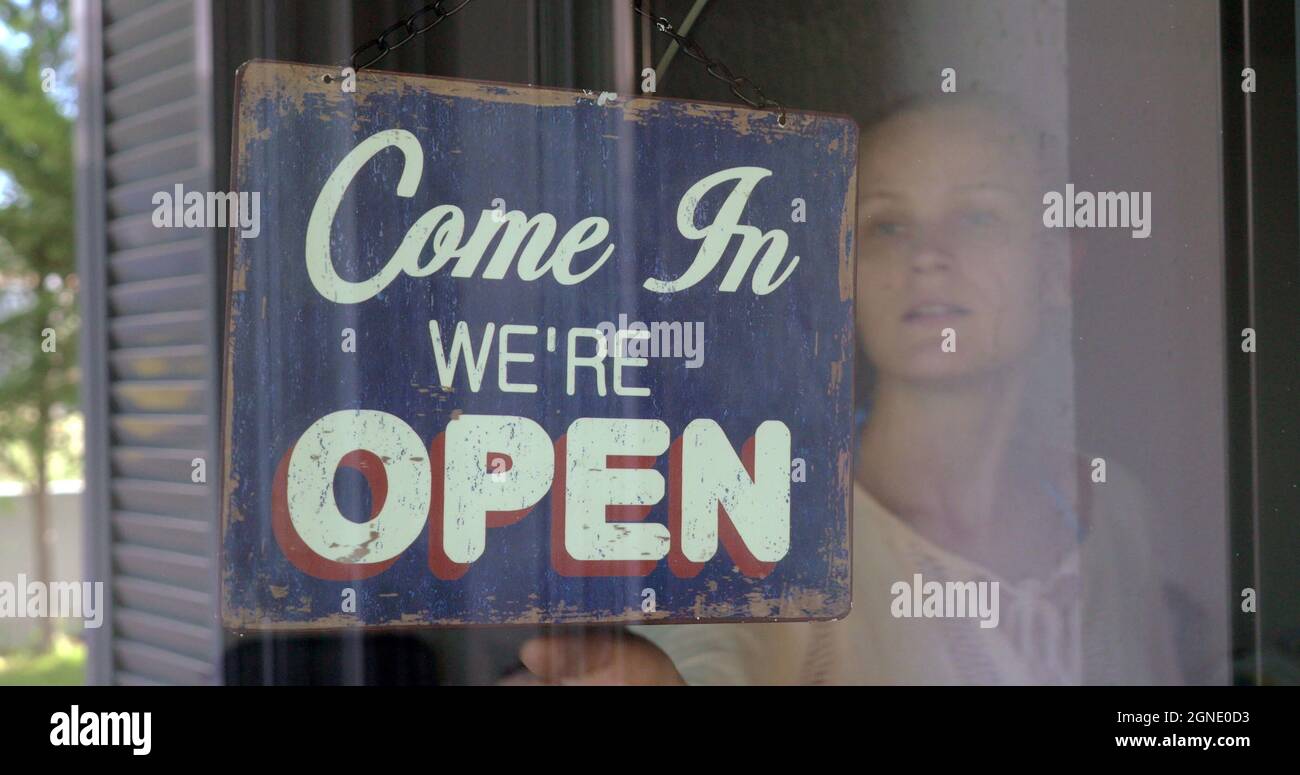 Woman closing the shop or cafe Stock Photo - Alamy
