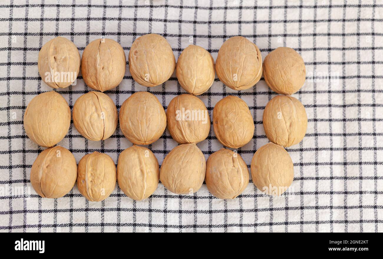 A lot of whole walnuts on a napkin close-up. Healthy, organic and ...