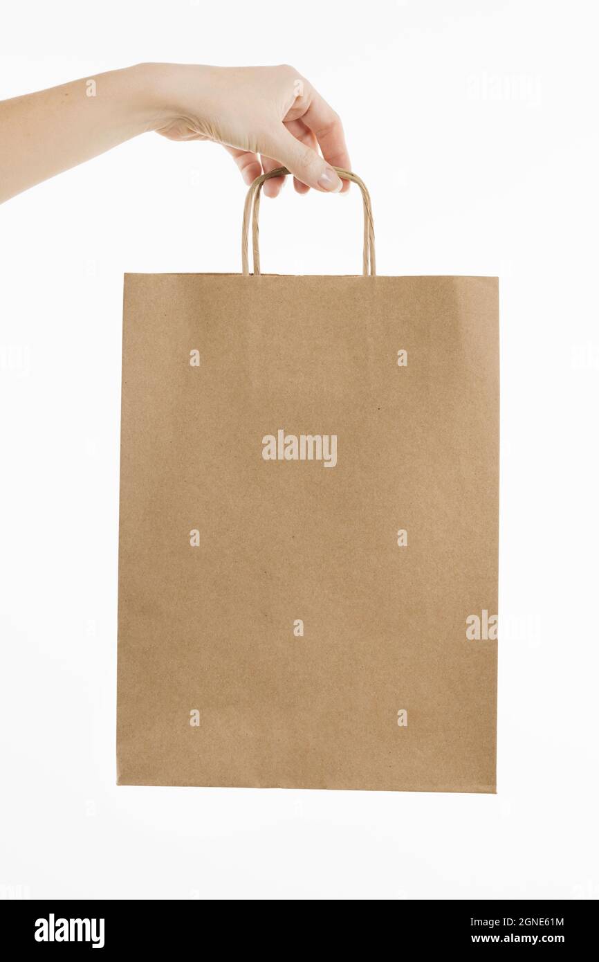 hand holding paper bag. High quality and resolution beautiful photo ...
