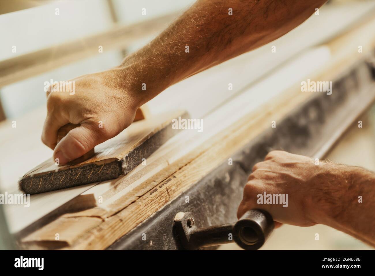 strong arms of a carpenter craftsman maneuvering woodworking tools ...