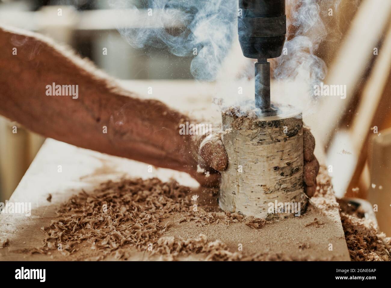 Carpenter drilling into a section of wood with a high speed drill ...