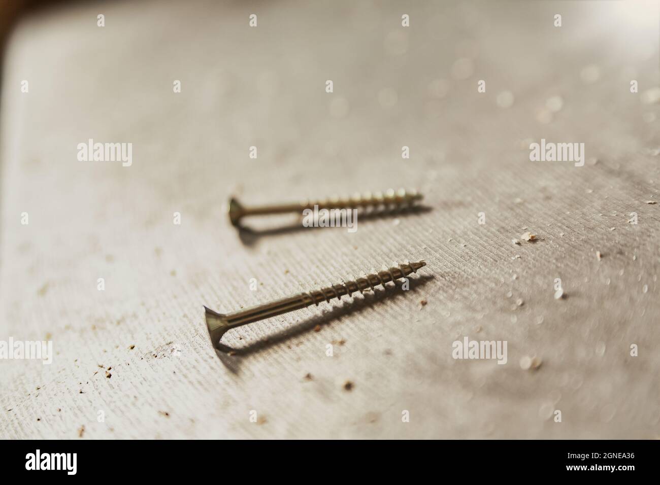 Focus to a threaded wood screw lying on a workbench in a carpentry ...