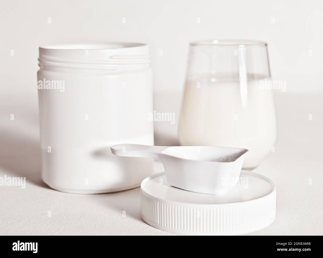 collagen peptides powder in a white unbranded container and glass with ...