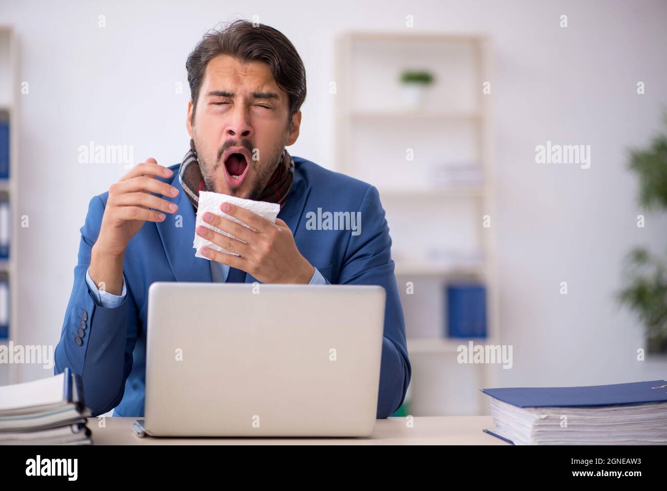 Young businessman employee suffering at workplace Stock Photo - Alamy