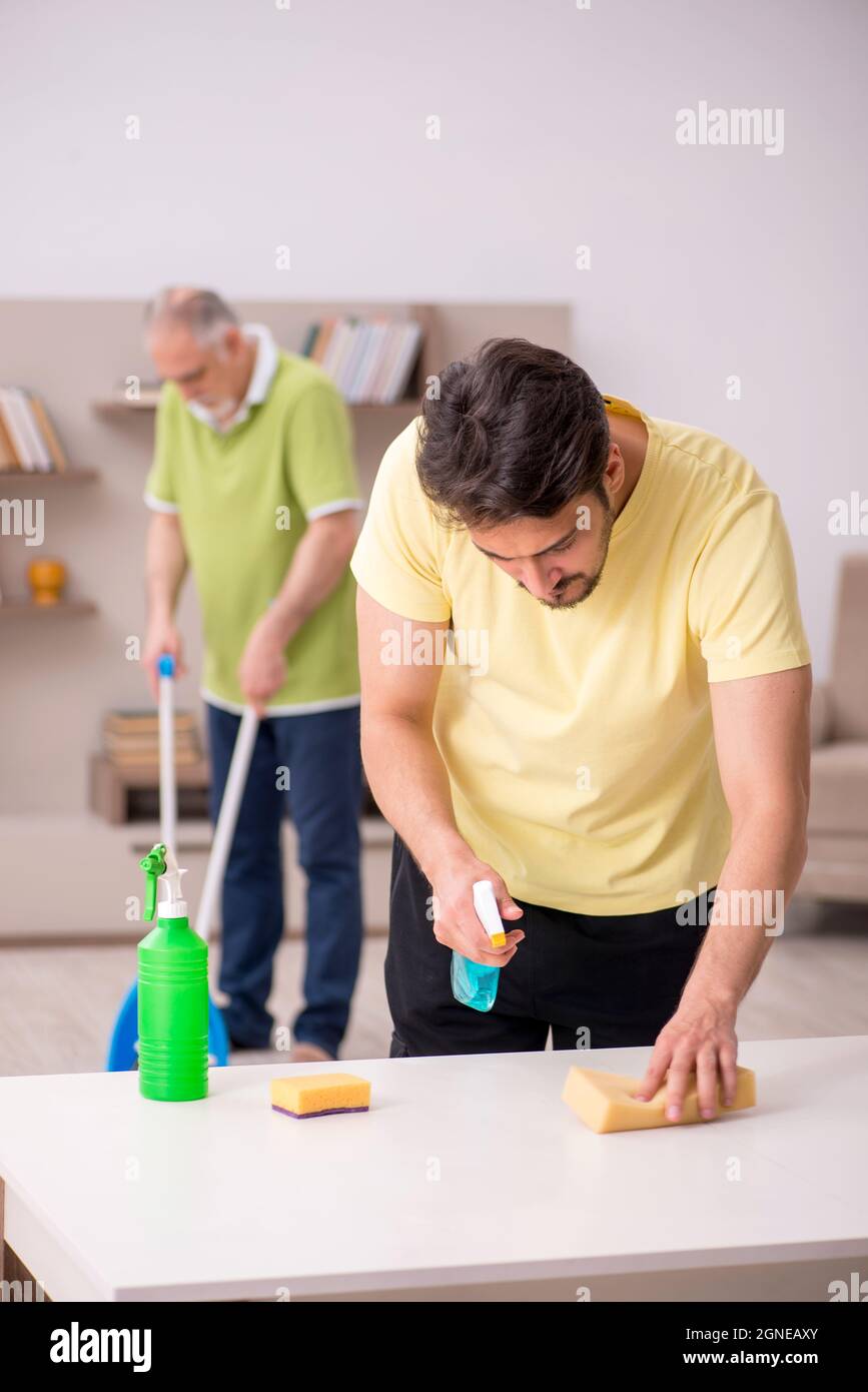 Two contractors cleaning the house Stock Photo - Alamy