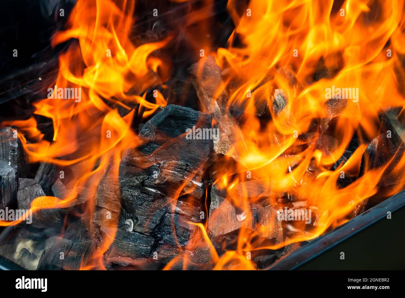 Barbecue grill pit with glowing and flaming hot open fire with red ...