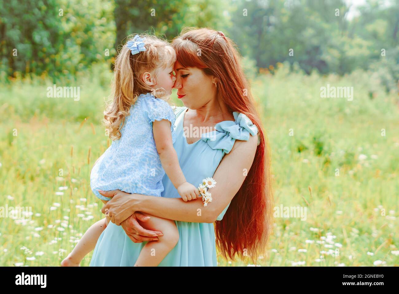 mom hugs her daughter in nature Stock Photo - Alamy
