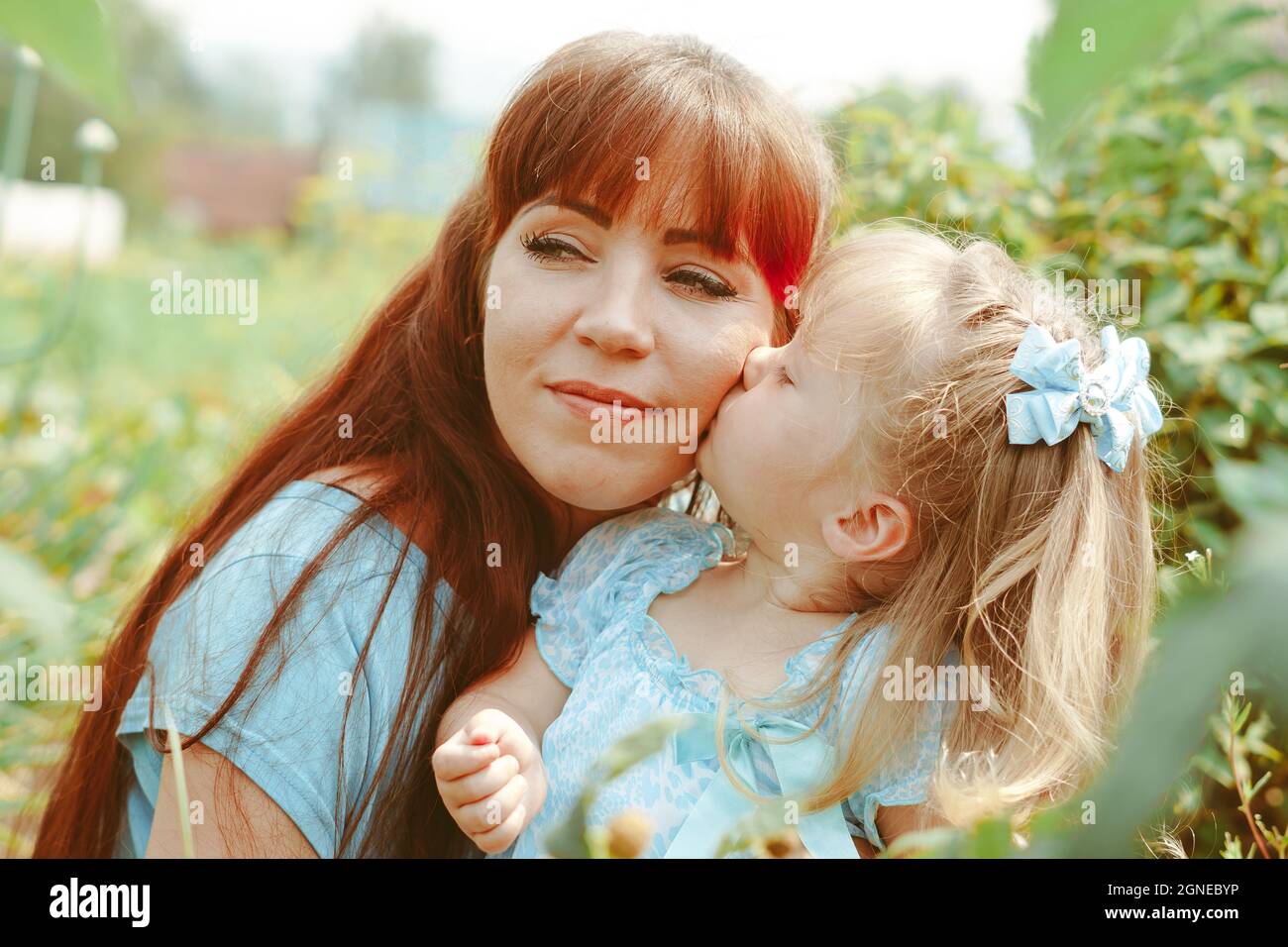 mom hugs her daughter in nature Stock Photo - Alamy