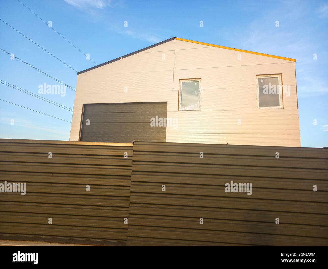 Warehouse building with fence. Industrial warehouse Stock Photo - Alamy