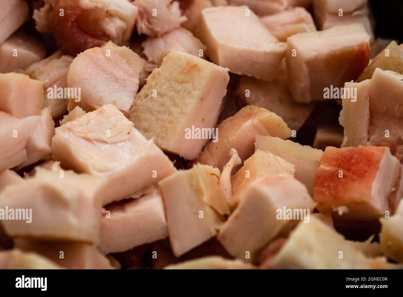 Butcher cutting little pieces of fat pork meat Stock Photo - Alamy