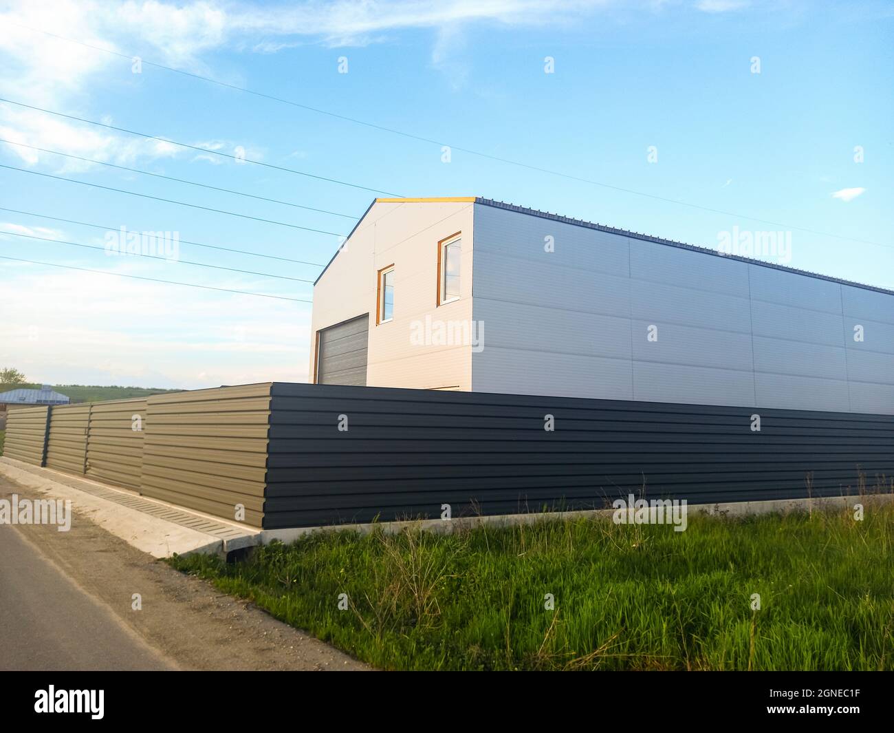 Warehouse building with fence. Industrial warehouse Stock Photo - Alamy