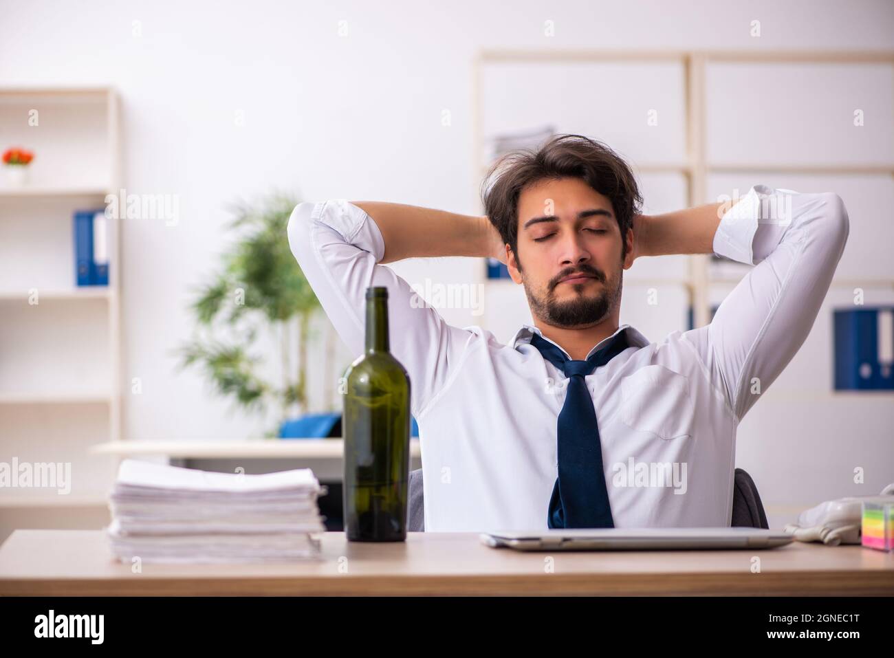 Male alcohol addicted employee sitting in the office Stock Photo - Alamy