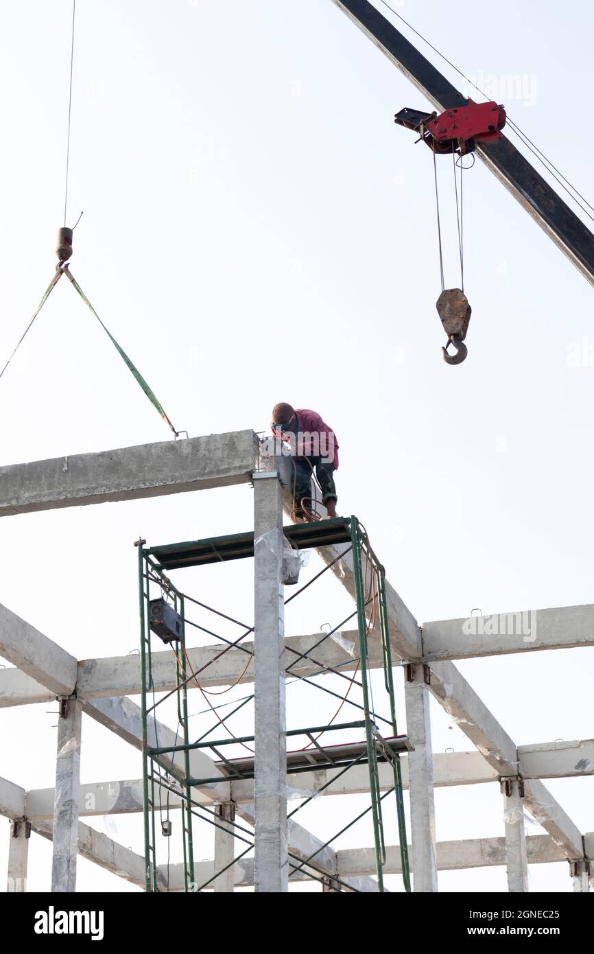 precast concrete beam installed at construction site by mobile crane ; civil engineering ...