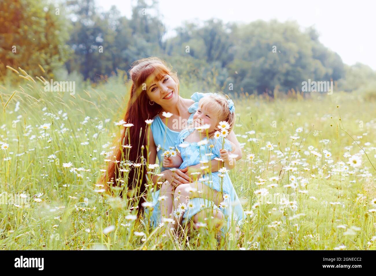 mom hugs her daughter in nature Stock Photo - Alamy