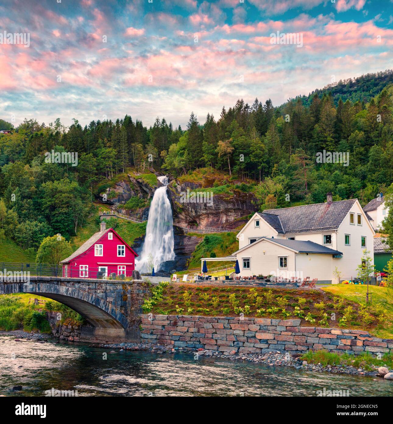 Splendid summer sunset with Large, popular waterfall Steinsdalsfossen ...