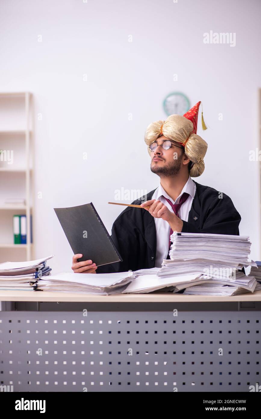 Funny young employee magician and too much work in the office Stock ...