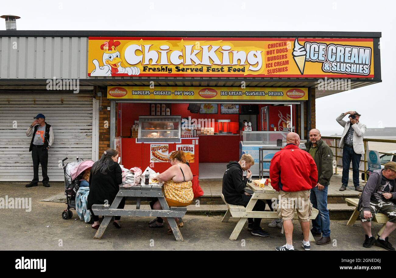 People pictured outside eating at a fast food outlet called ChickKing ...