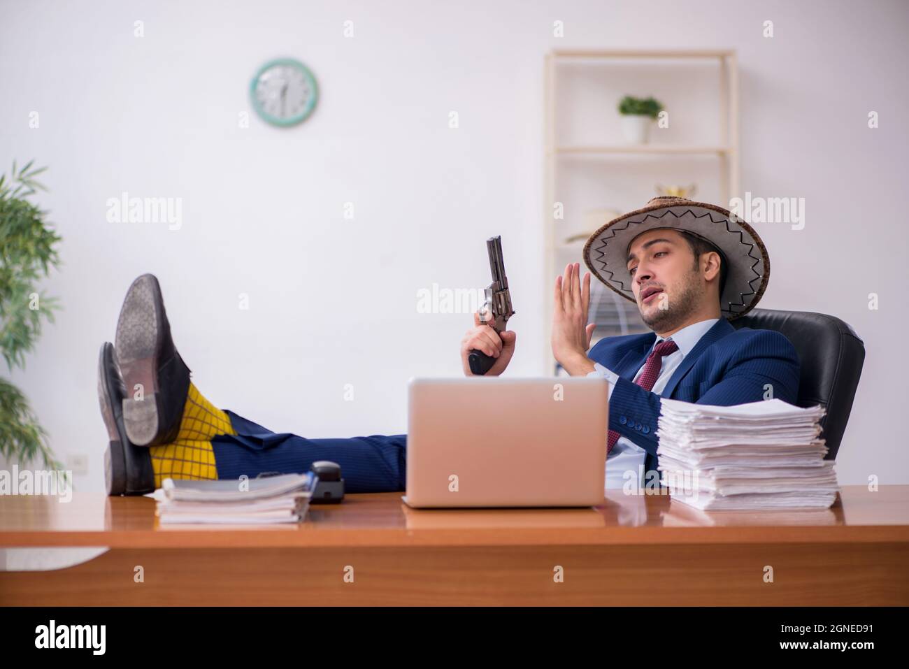 Young cowboy employee working at workplace Stock Photo - Alamy