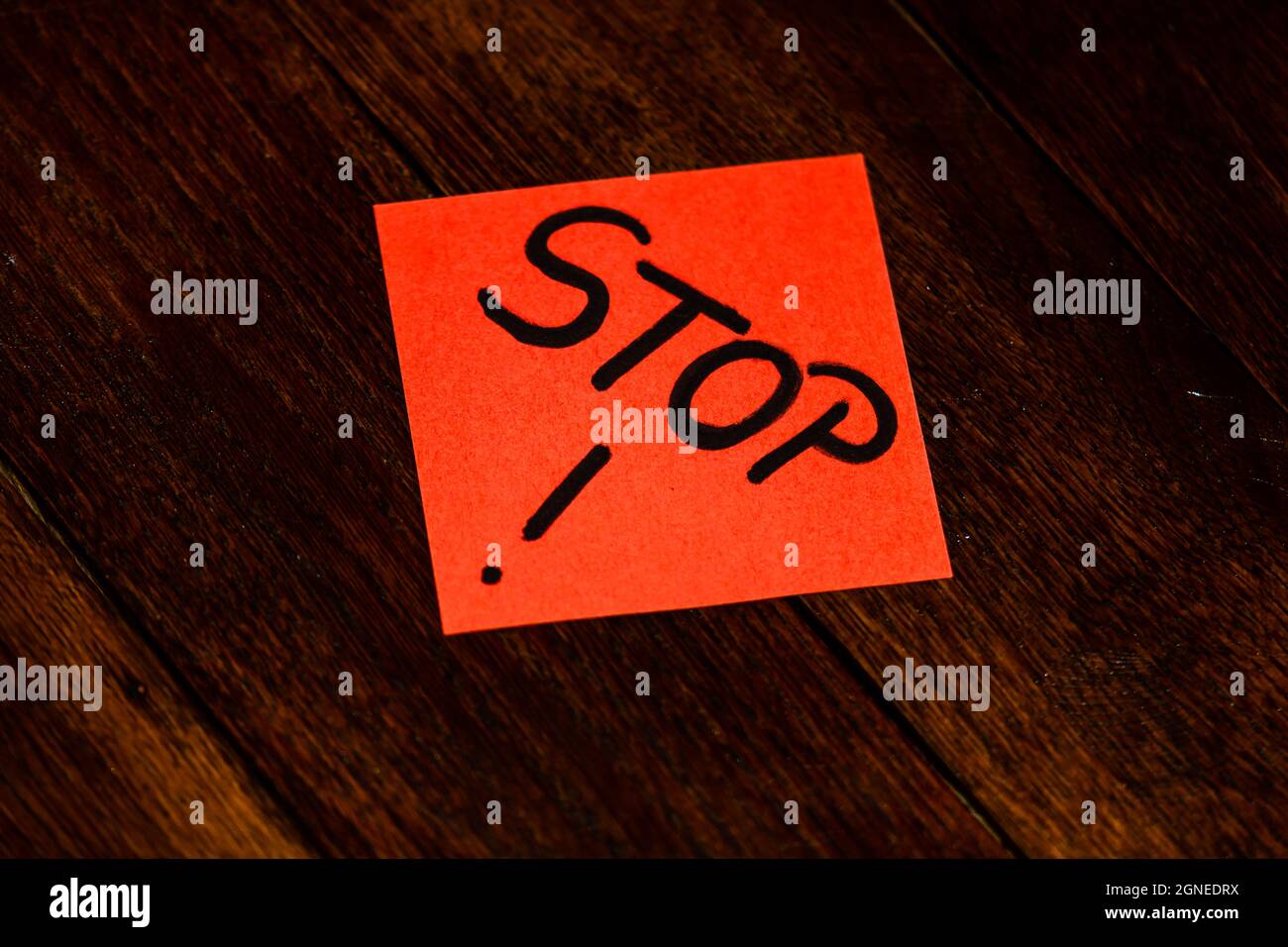STOP sign on wooden table. Warning note Stock Photo - Alamy