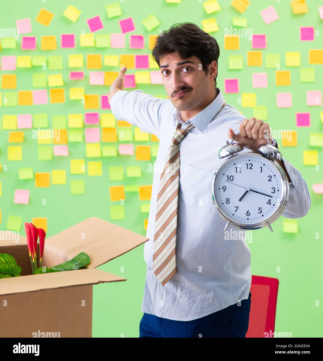 Man collecting his stuff after redundancy in the office with many ...