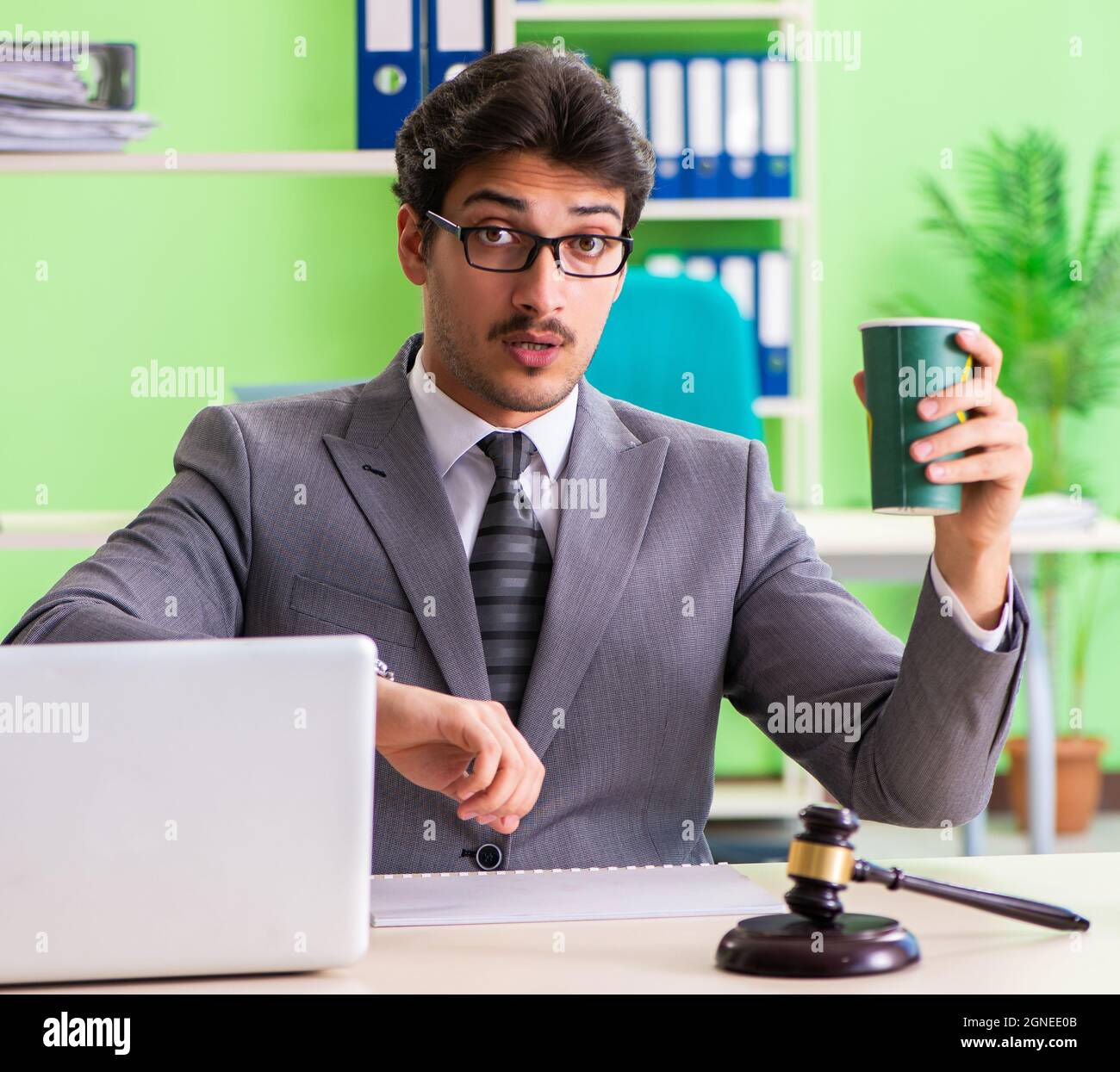 The young handsome lawyer working in the office Stock Photo - Alamy