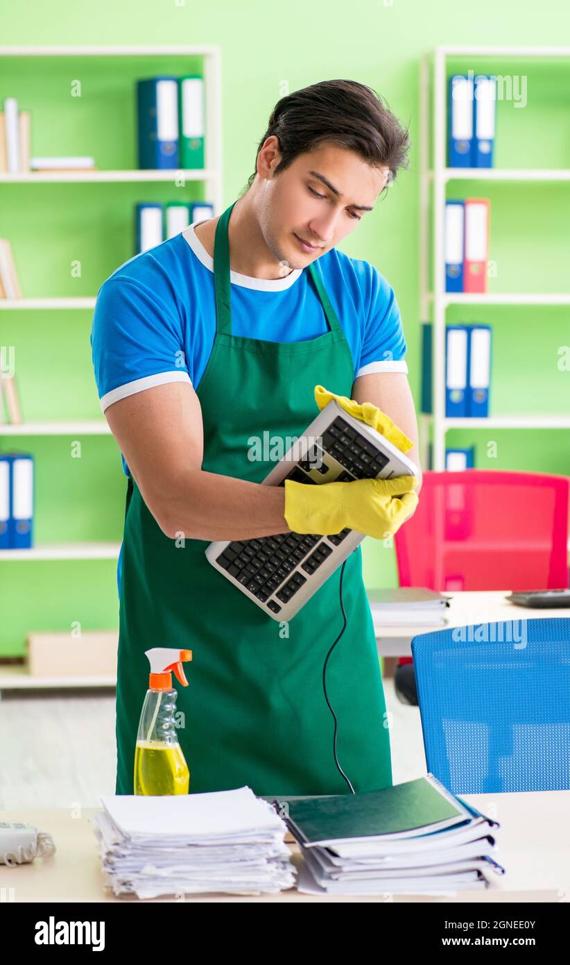 The male handsome professional cleaner working in the office Stock ...