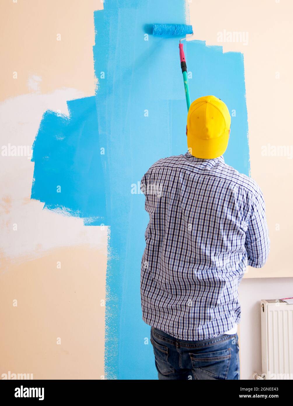 The painter man painting the wall at home Stock Photo - Alamy